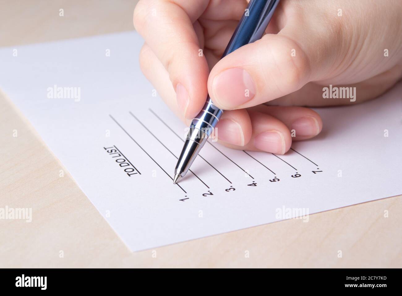 female hand filling to do list with blue pen Stock Photo - Alamy