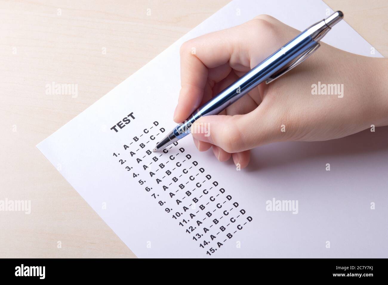 female hand filling test score sheet with answers Stock Photo - Alamy
