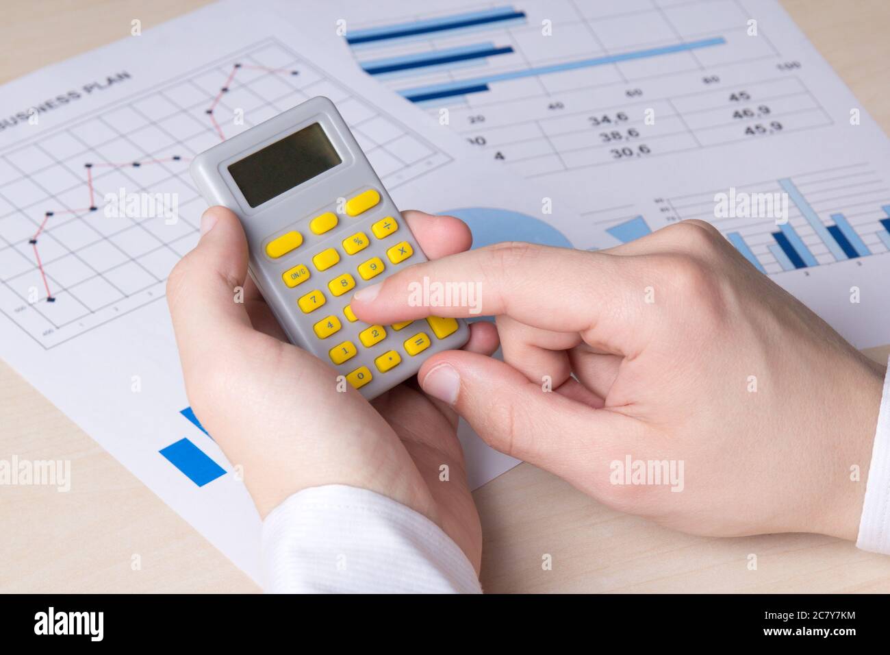 close up of bussinessman hands accounting something with calculator ...
