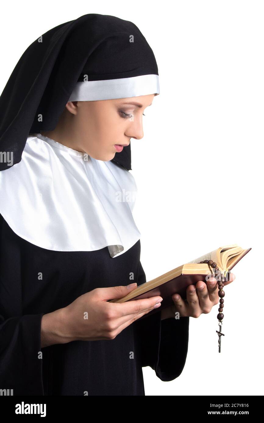 young beautiful woman nun with bible and rosary isolated on white ...