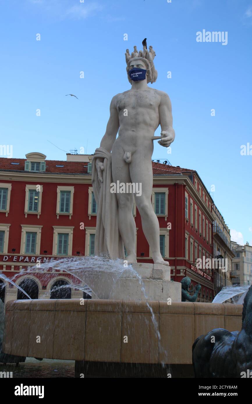 Statue on fountain giving example of wearing mask in Place Massena ...