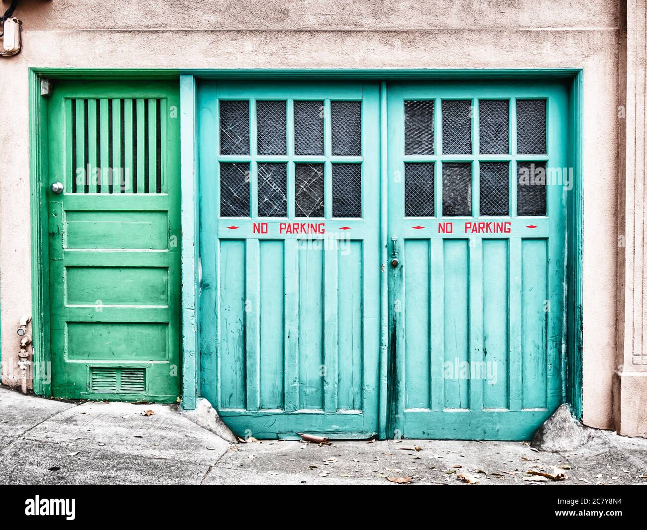 Old concrete building with green gates and no parking sign Stock Photo ...