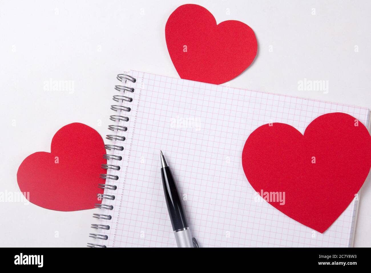 love letter concept - note book with pen and red paper hearts Stock ...