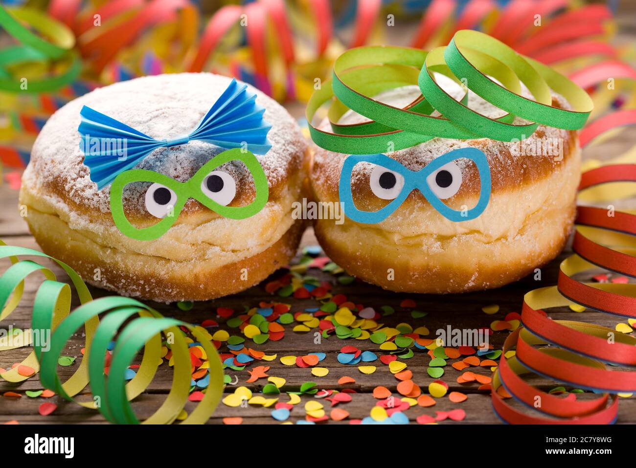 Carnival doughnuts with funny faces and paper streamers Stock Photo - Alamy