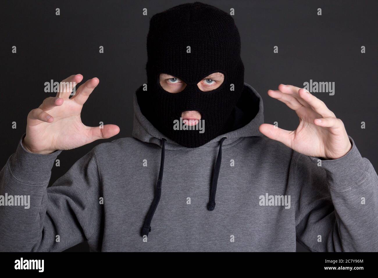 angry man criminal in black mask over grey background Stock Photo - Alamy