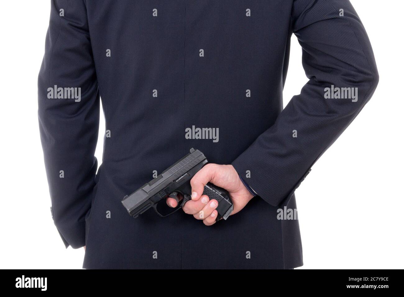 man hiding gun behind his back isolated on white background Stock Photo ...