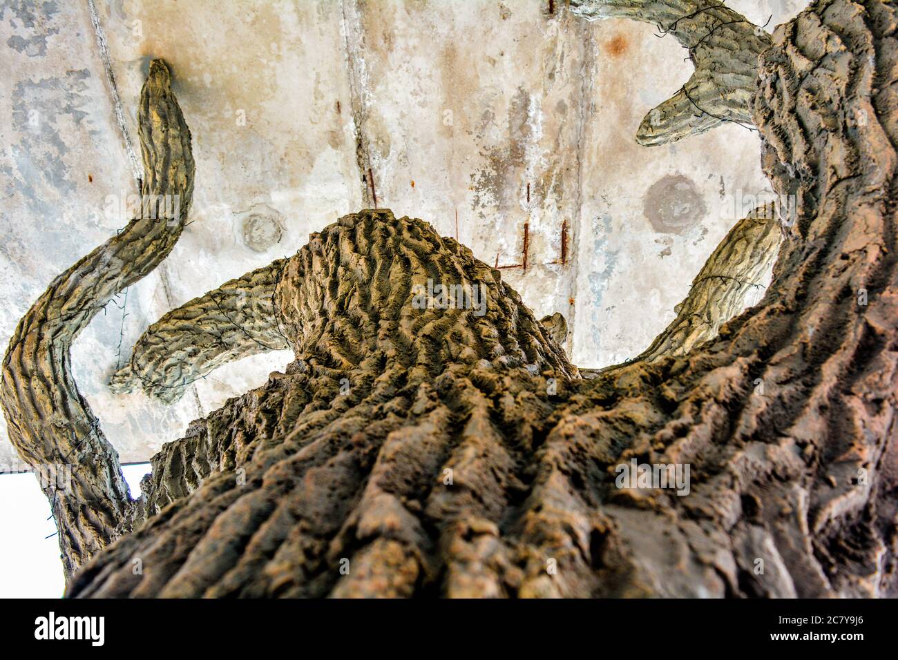Clumsy artificial tree supports roof like decorative pillar ...