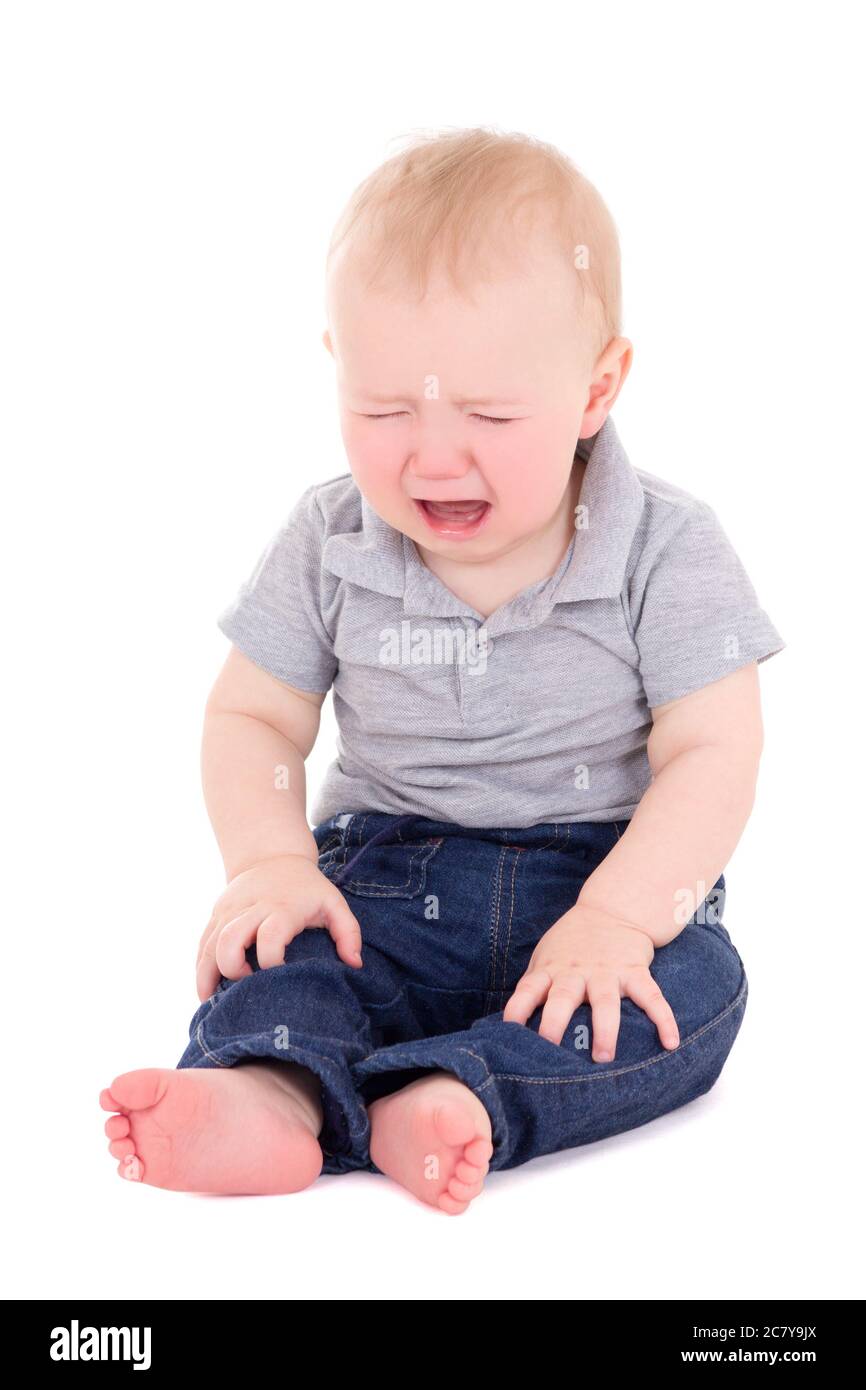 crying baby boy sitting isolated on white background Stock Photo - Alamy