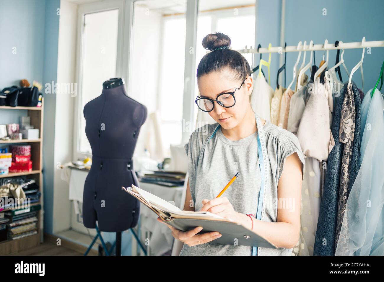 Tailor choosing suit textile from list of samples Stock Photo - Alamy