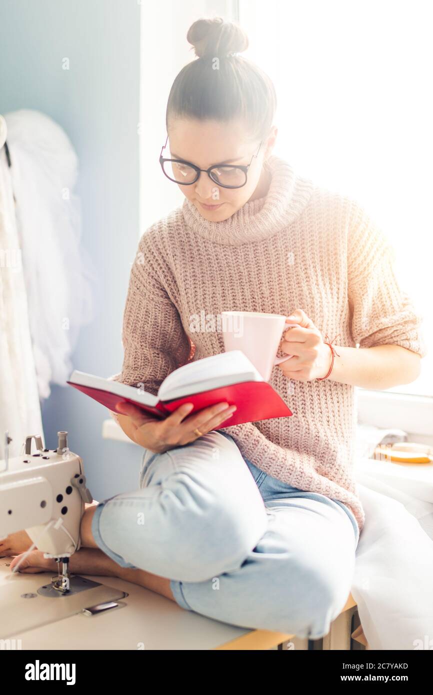 Tailor choosing suit textile from list of samples Stock Photo - Alamy