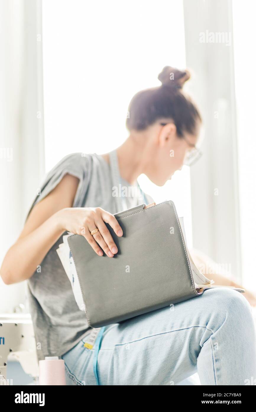 Dressmaker designing clothes pattern on paper Stock Photo - Alamy