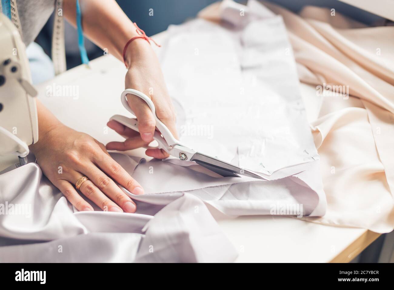 Young dressmaker cutting cloth, close up Stock Photo - Alamy