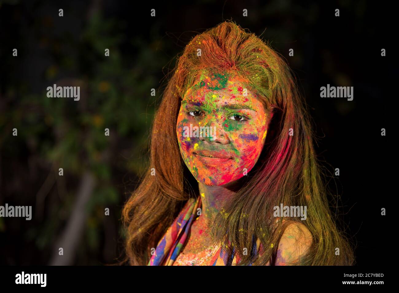 A young girl plays with colors. The concept for Indian festival Holi ...