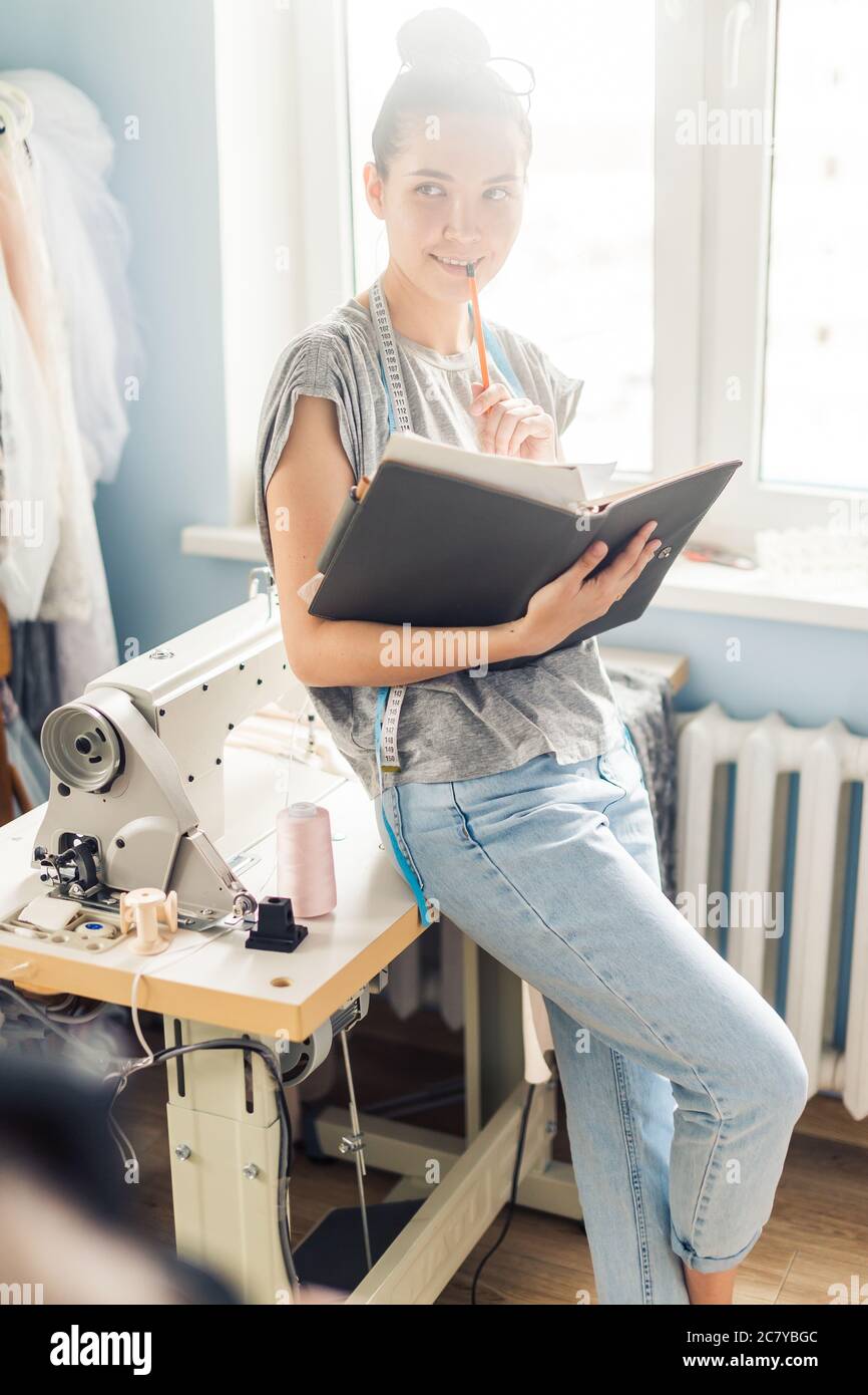 Dressmaker designing clothes pattern on paper Stock Photo - Alamy