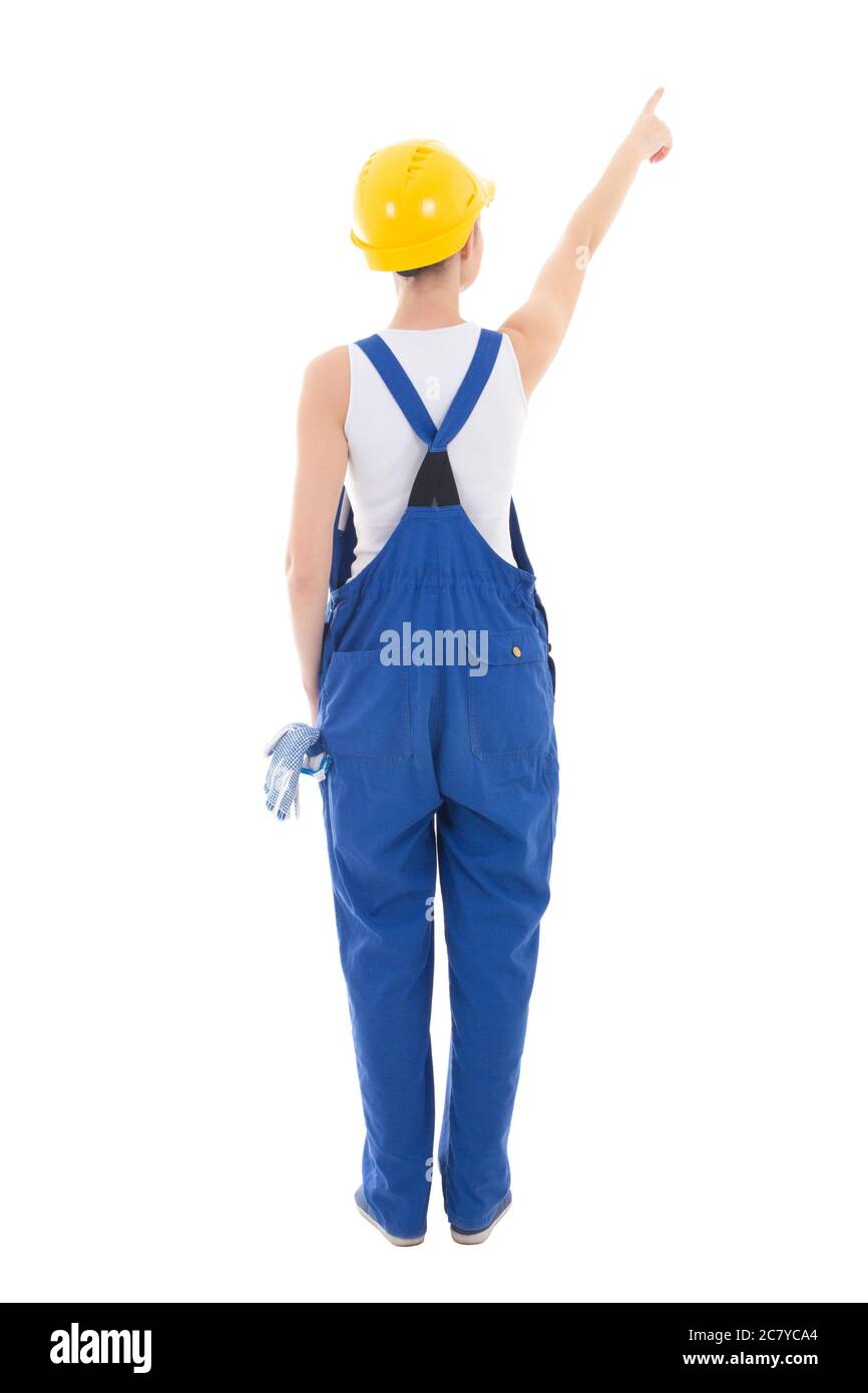 back view of young woman builder pointing at something isolated on ...