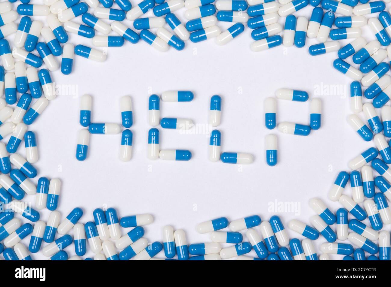 help word text made of blue tablets, pills and capsules on white ...