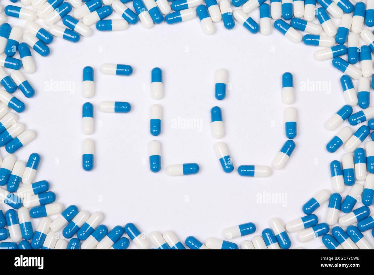 flu word text made of blue tablets, pills and capsules on white ...