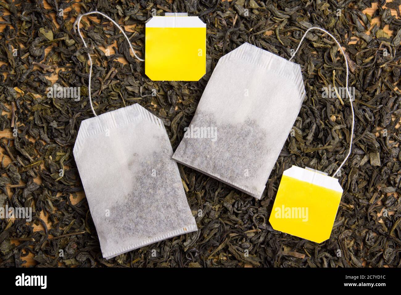 background with dried black tea and two tea bags Stock Photo - Alamy