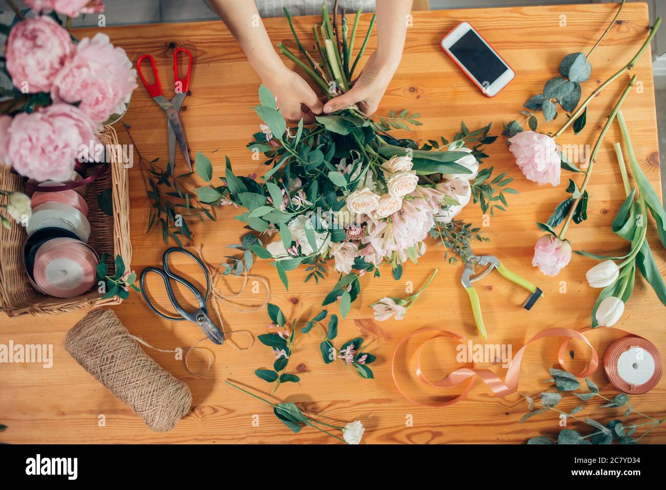 Small business. Flowers delivery top view. Florists creating order ...