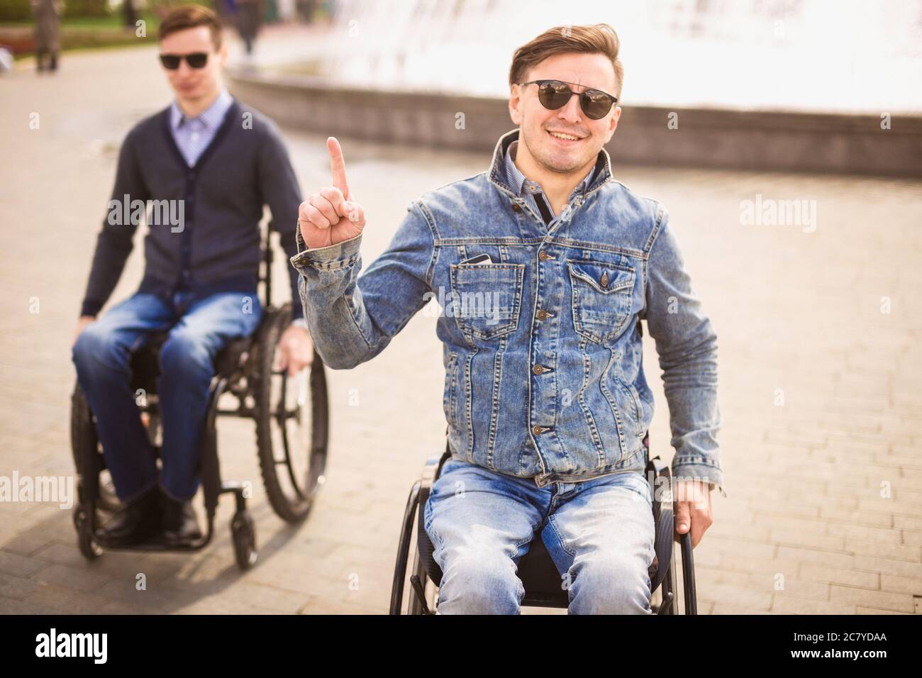 Disabled Happy friends having fun together outside Stock Photo - Alamy