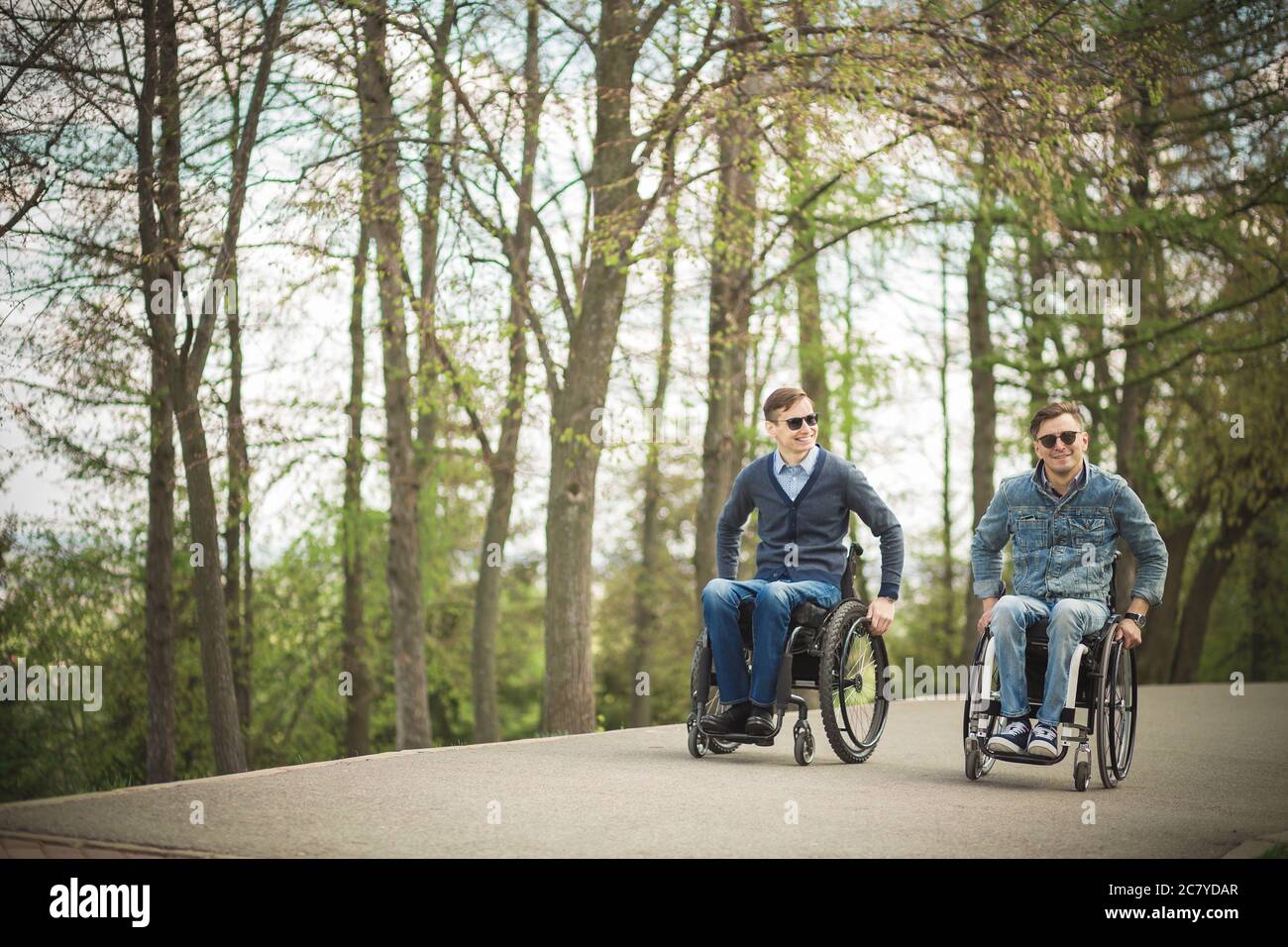 two disabled friends ride in the Park and enjoy Stock Photo - Alamy