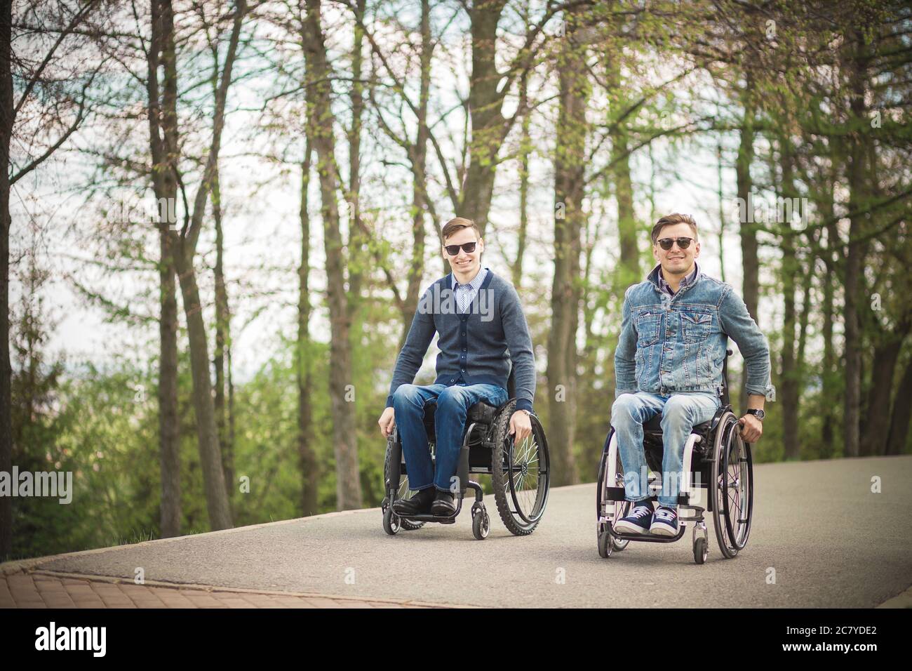 Disabled Happy friends having fun together outside Stock Photo - Alamy