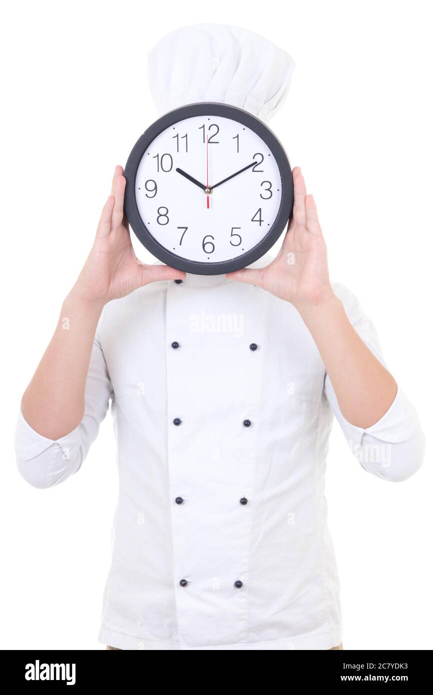 young man chef in uniform holding office clock behind his face isolated ...