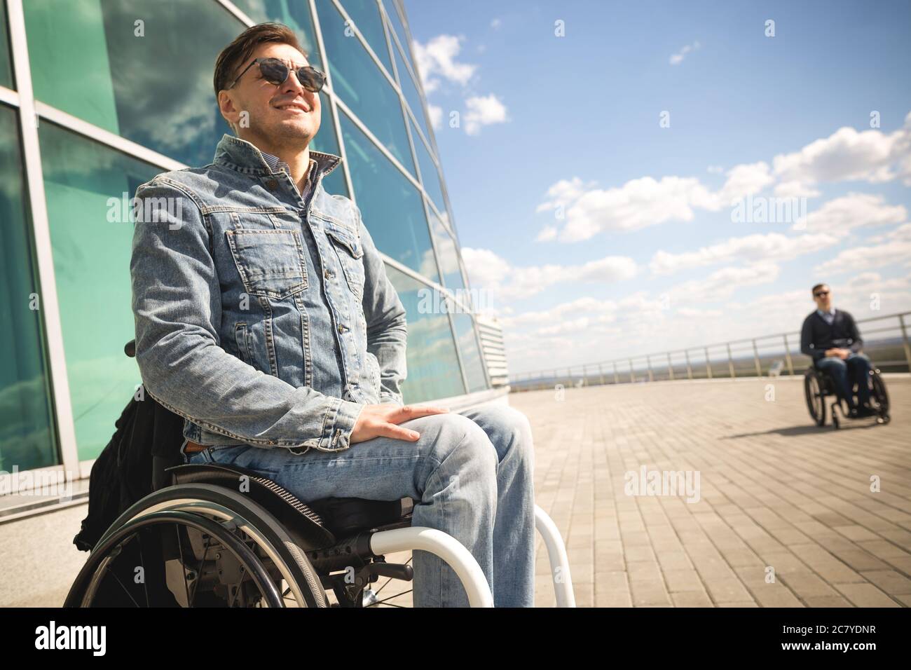 Happy man at park. A guy in a wheelchair Stock Photo - Alamy