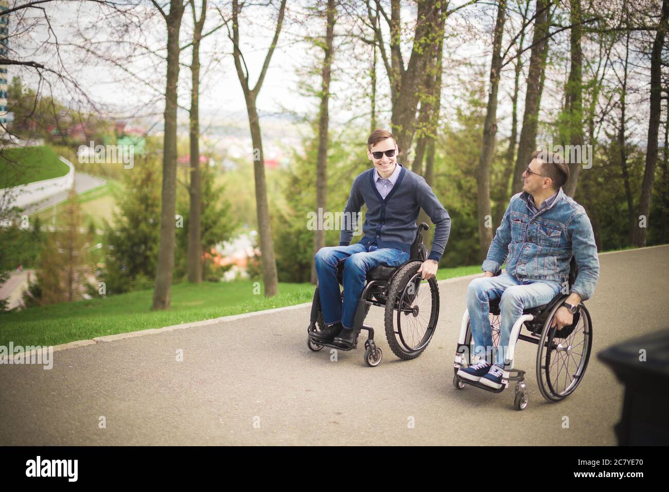 Disabled Happy friends having fun together outside Stock Photo - Alamy