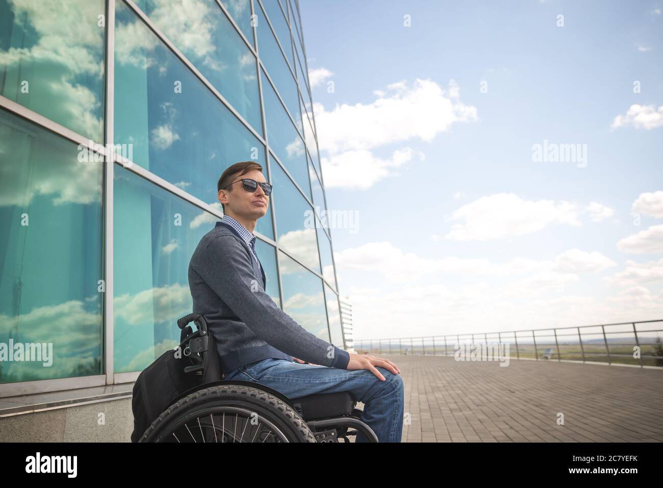 Invalid man sitting on a wheel chair and enjoying a walk outdoors Stock ...