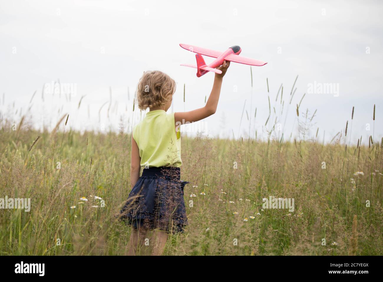 Happy kid playing with toy airplane Stock Photo - Alamy