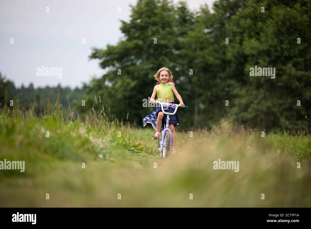 Symbol of celebration 4 fourth of july. Young Girl riding bicycle with ...