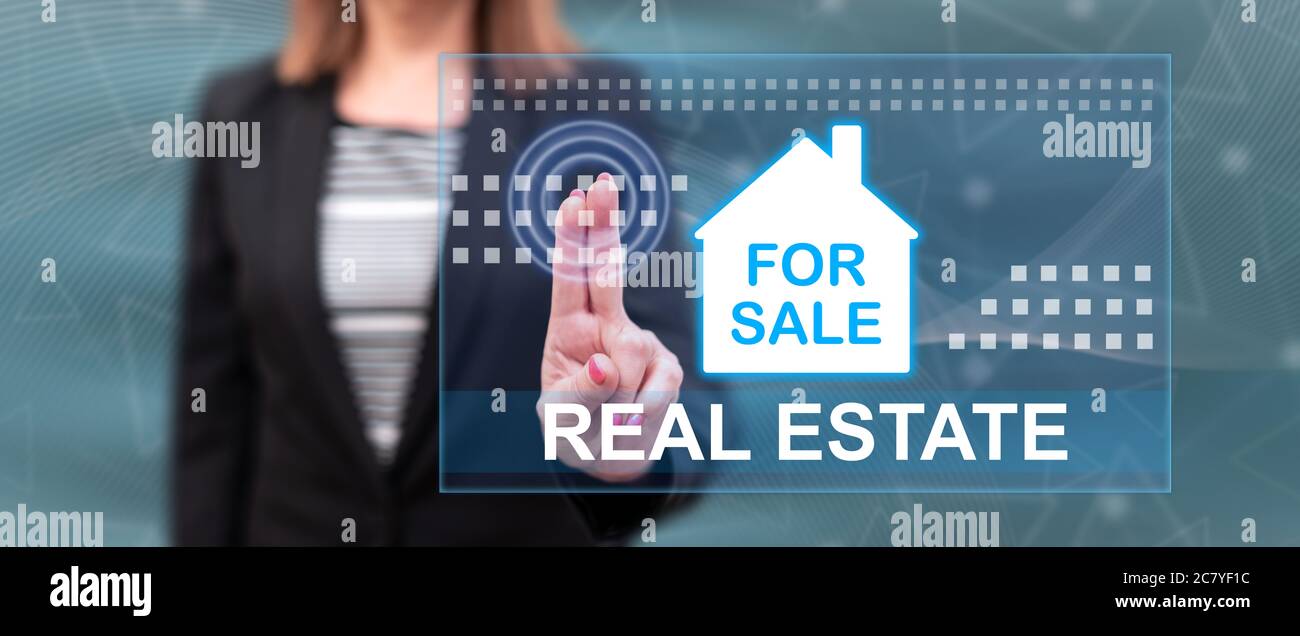 Woman touching a real estate concept on a touch screen with her fingers ...