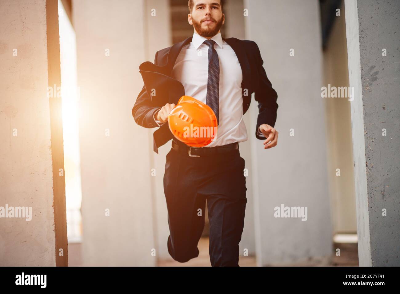 Construction worker running from danger on construction site Stock ...