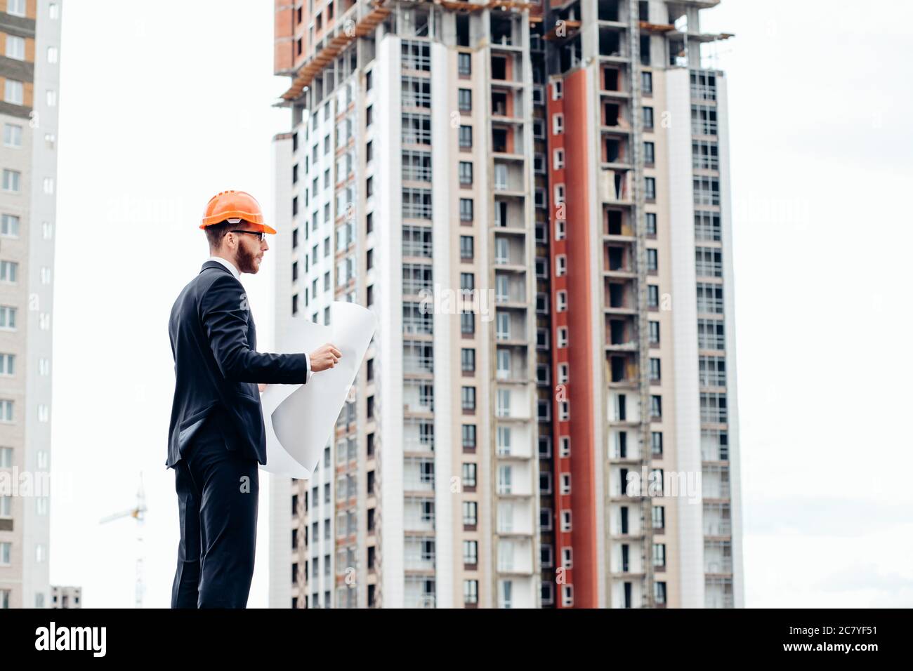 Construction: Young Couple Look At Home Plans with Builder Stock Photo ...