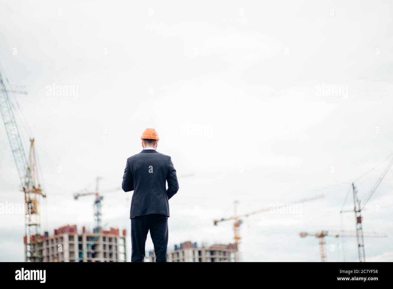 Back view of successful manager looking the construction site Stock ...