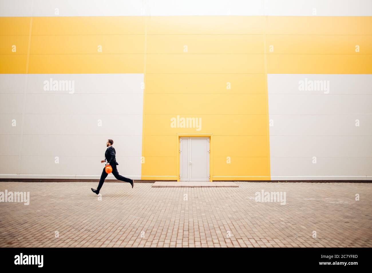 running engineer in helmet. Walking guy in motion. Businessman in blue ...