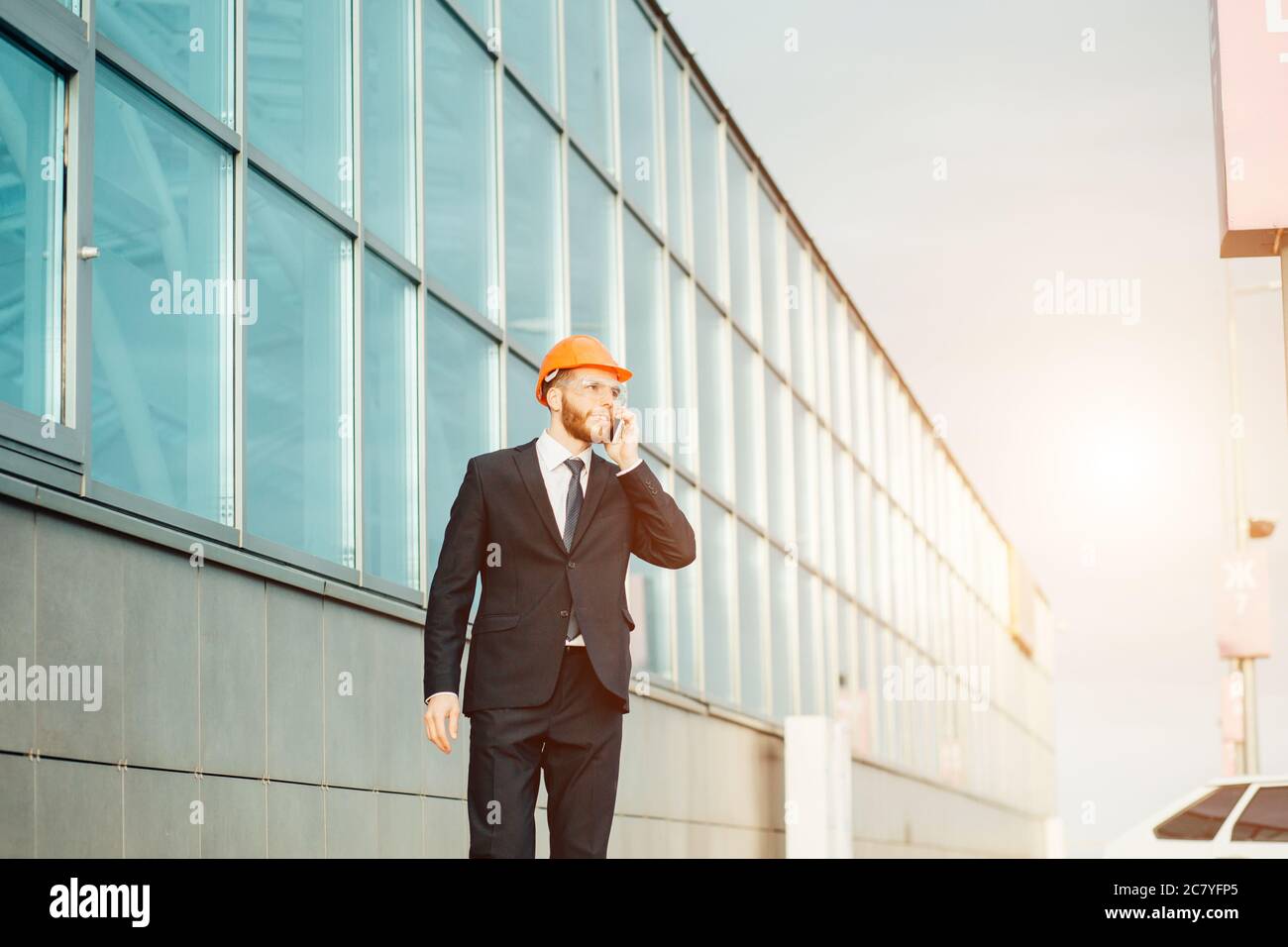 Builder On construction Site Using Mobile Phone Stock Photo - Alamy