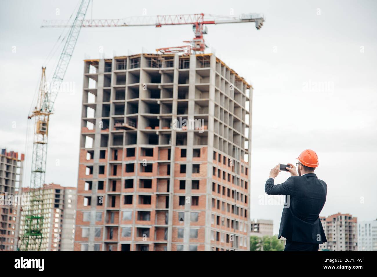 Engineer take a photo of construction site Stock Photo - Alamy