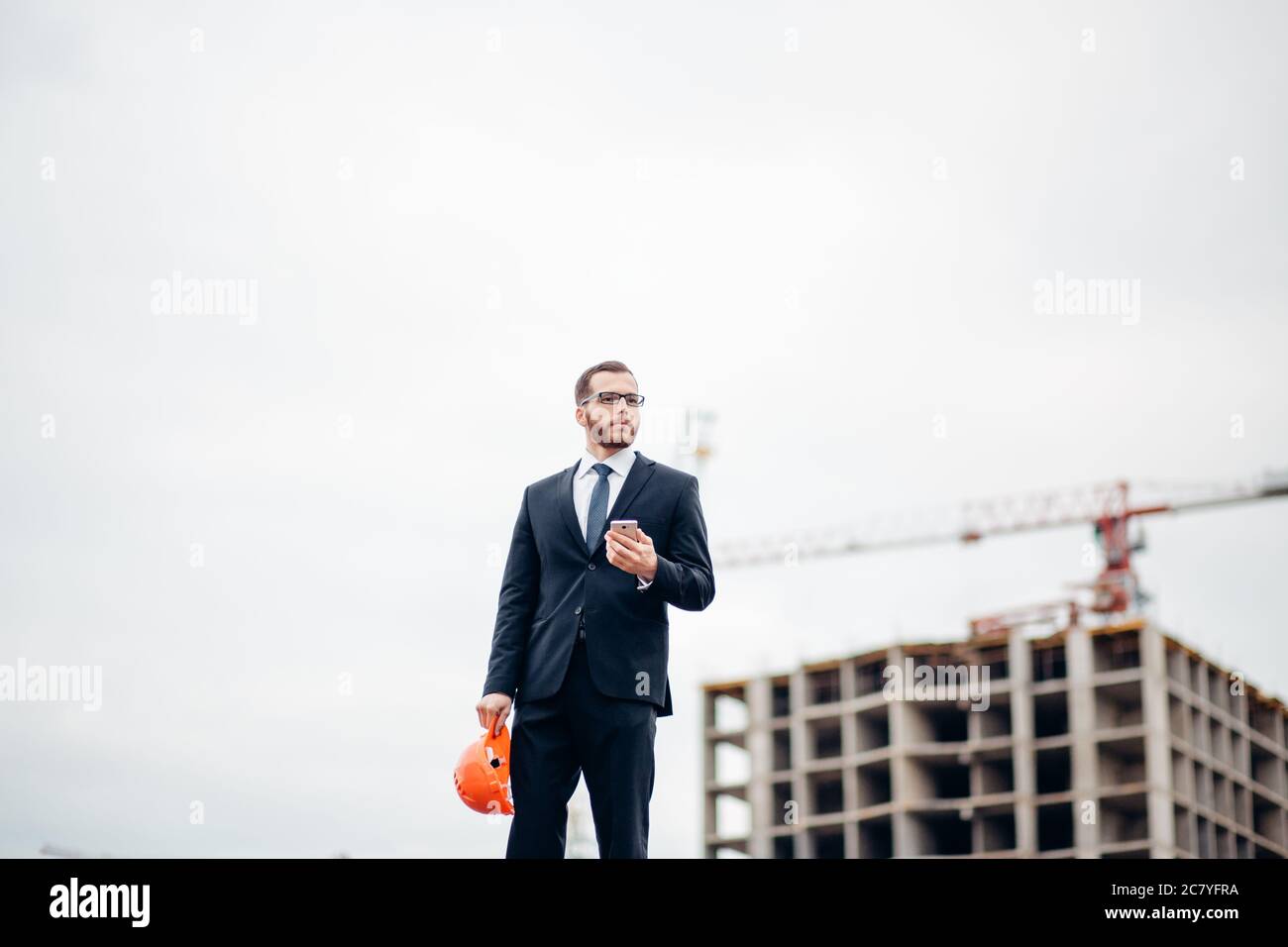 Engineer builder wearing suit and helmet at construction site Stock ...