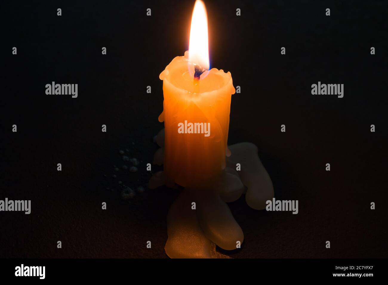 Burning candle with melting wax close-up on a black background Stock ...