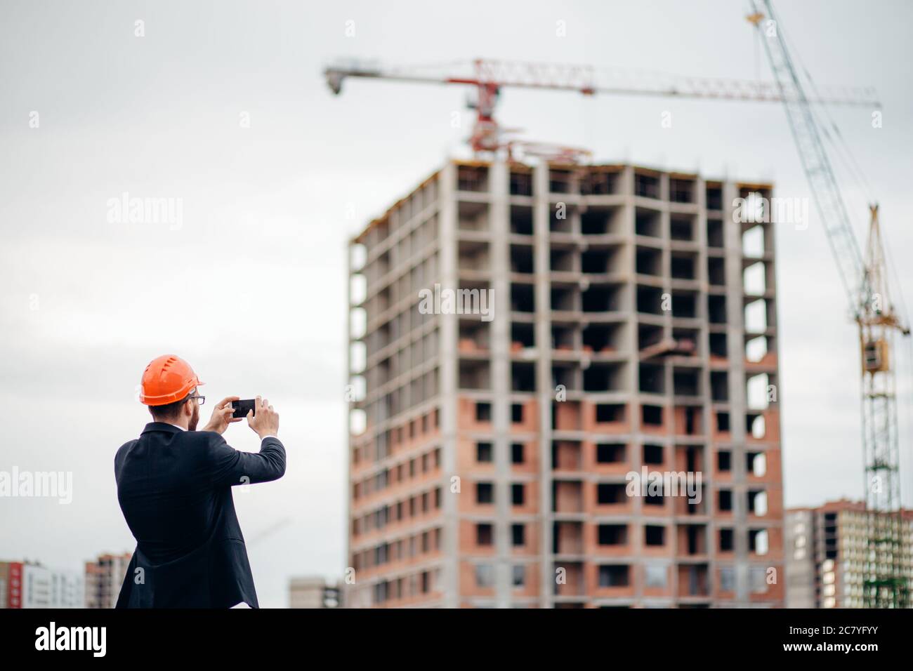 Engineer take a photo of construction site Stock Photo - Alamy