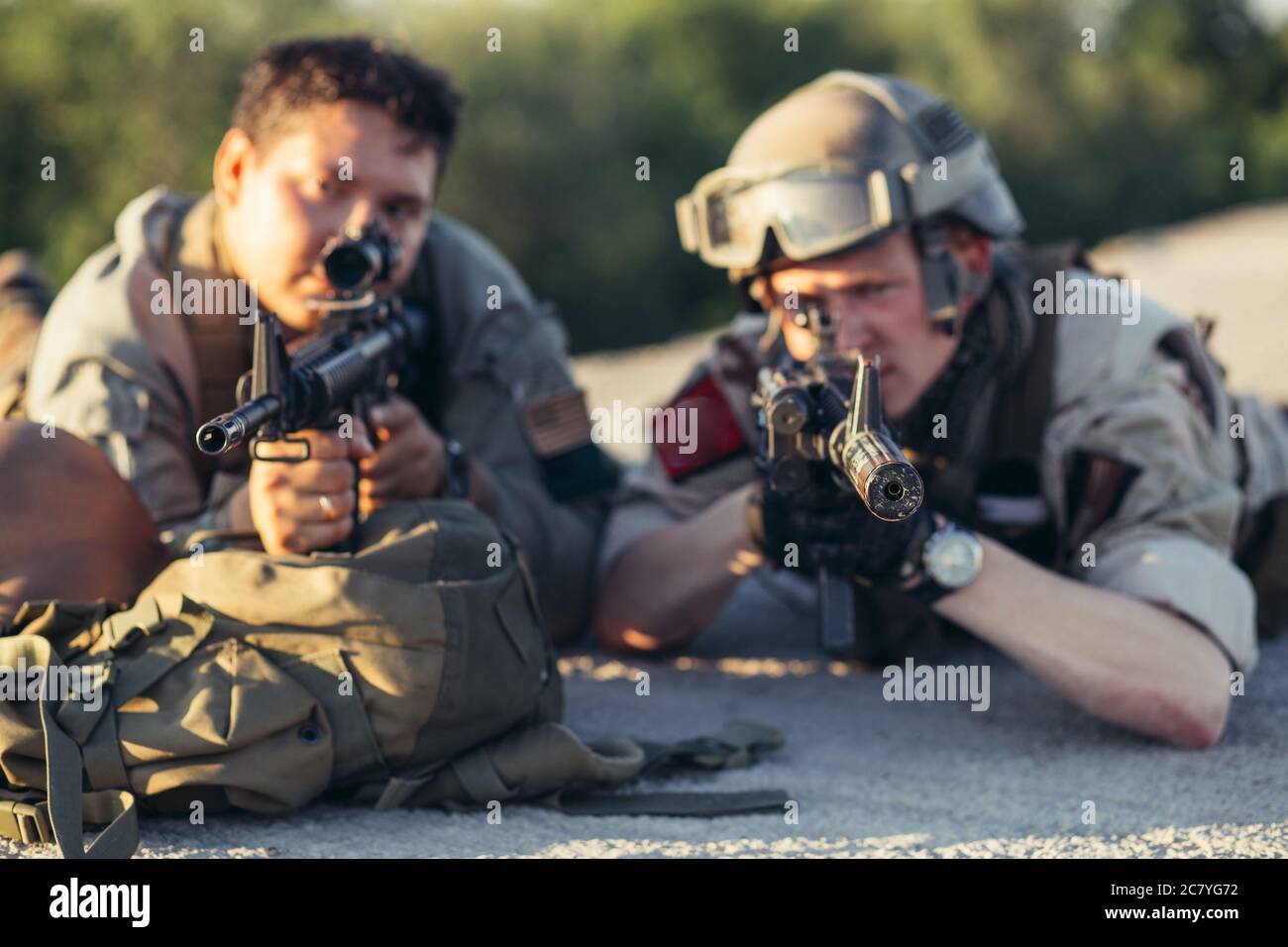 Side view on Soldiers Lie Down on the Hill, Aiming through the Assault ...