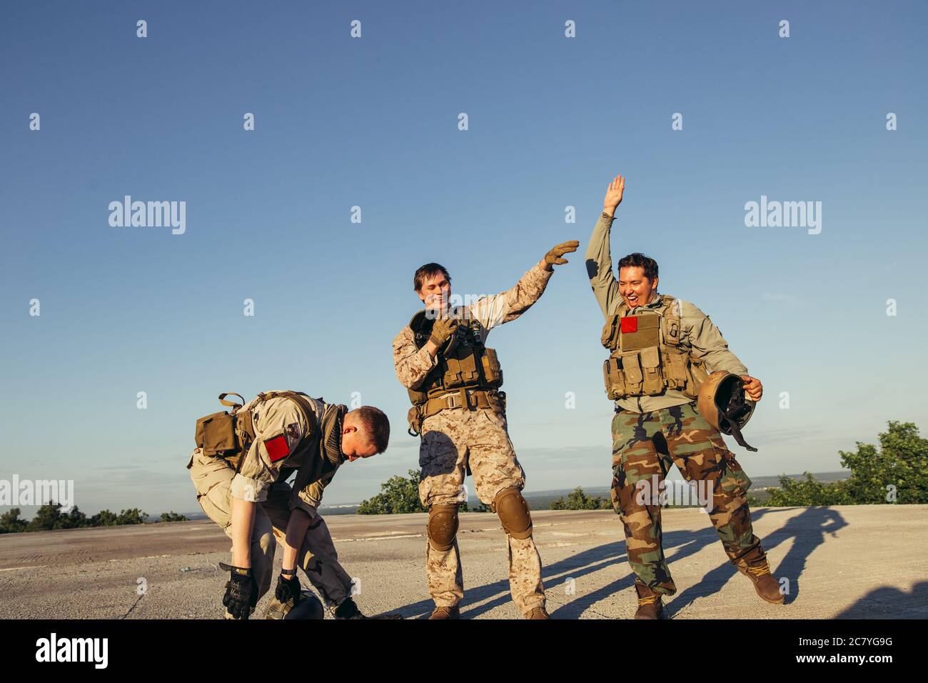 American soldiers celebrating the victory throwing hats in the air ...