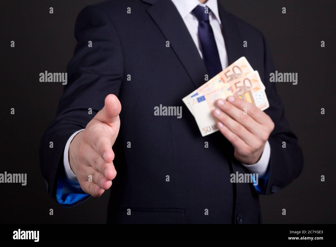 bribery concept - man in suit with euro banknotes ready to handshake ...