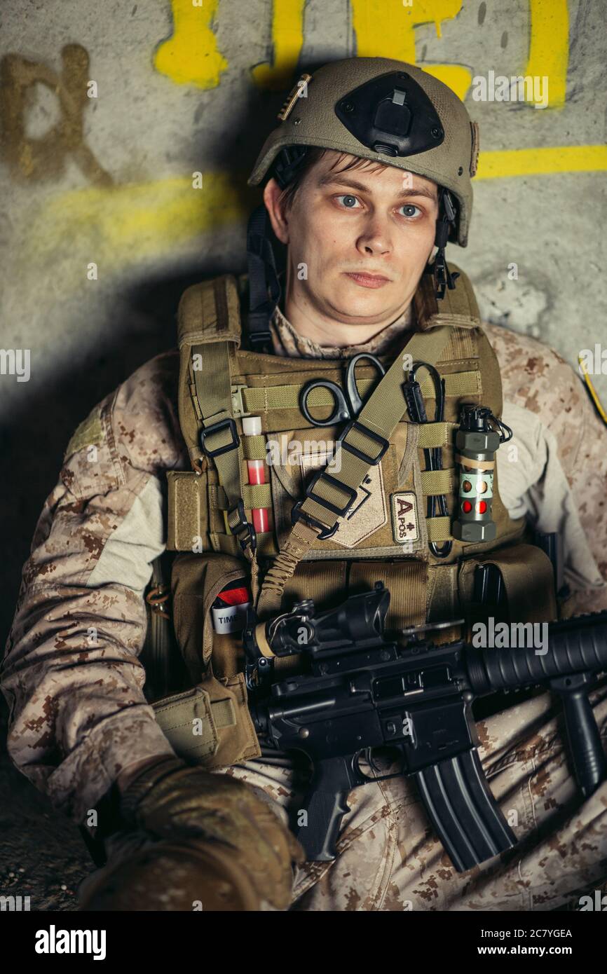 airsoft soldier with a rifle playing strikeball In an abandoned brick ...