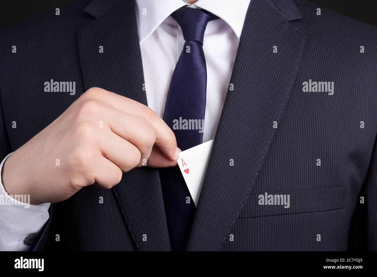 mans hand hiding ace card in business suit pocket Stock Photo - Alamy