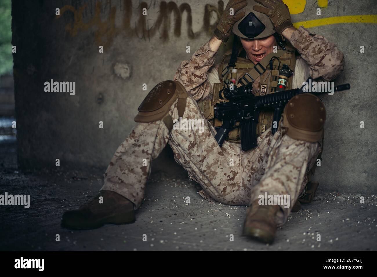 airsoft soldier with a rifle playing strikeball In an abandoned brick ...