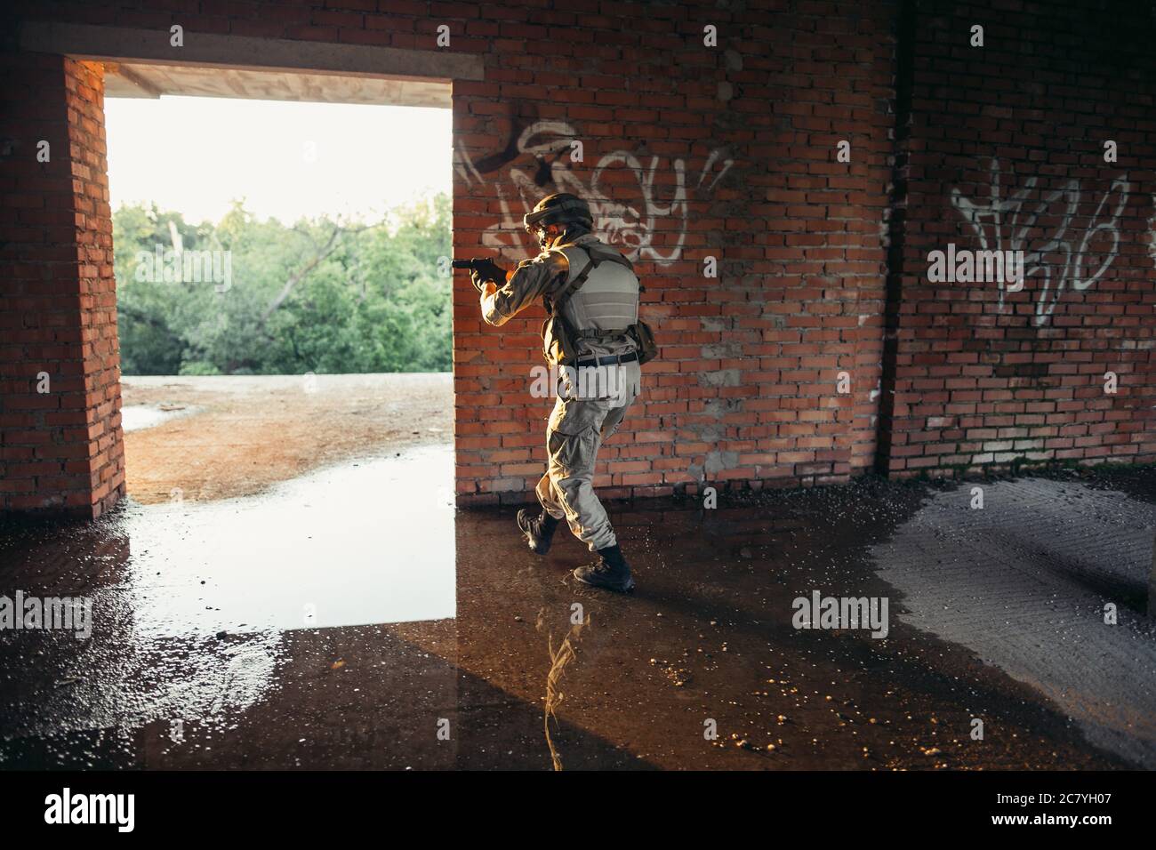 airsoft soldiers with a rifle playing strikeball In an abandoned brick ...