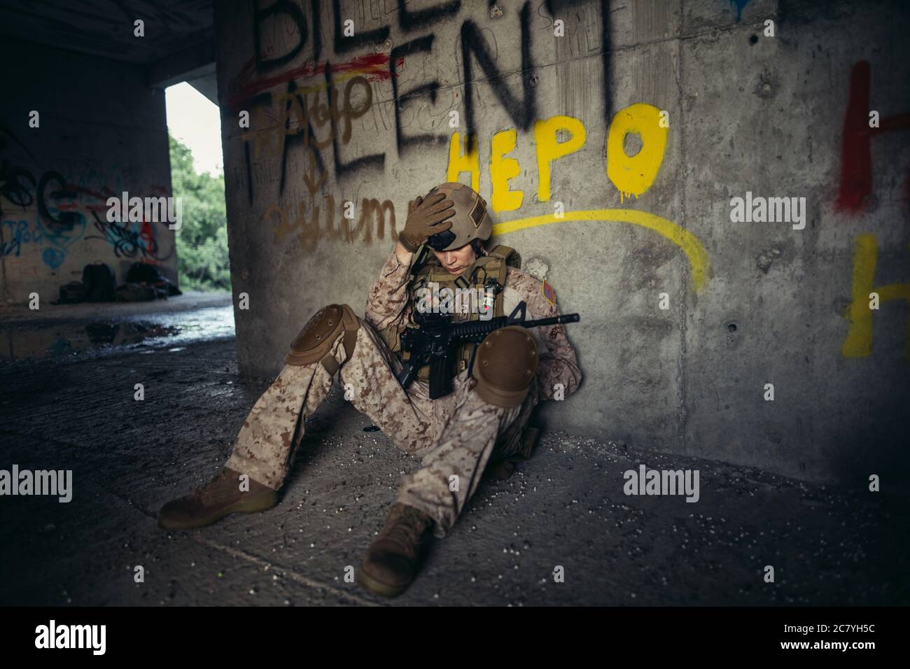 airsoft soldier with a rifle playing strikeball In an abandoned brick ...